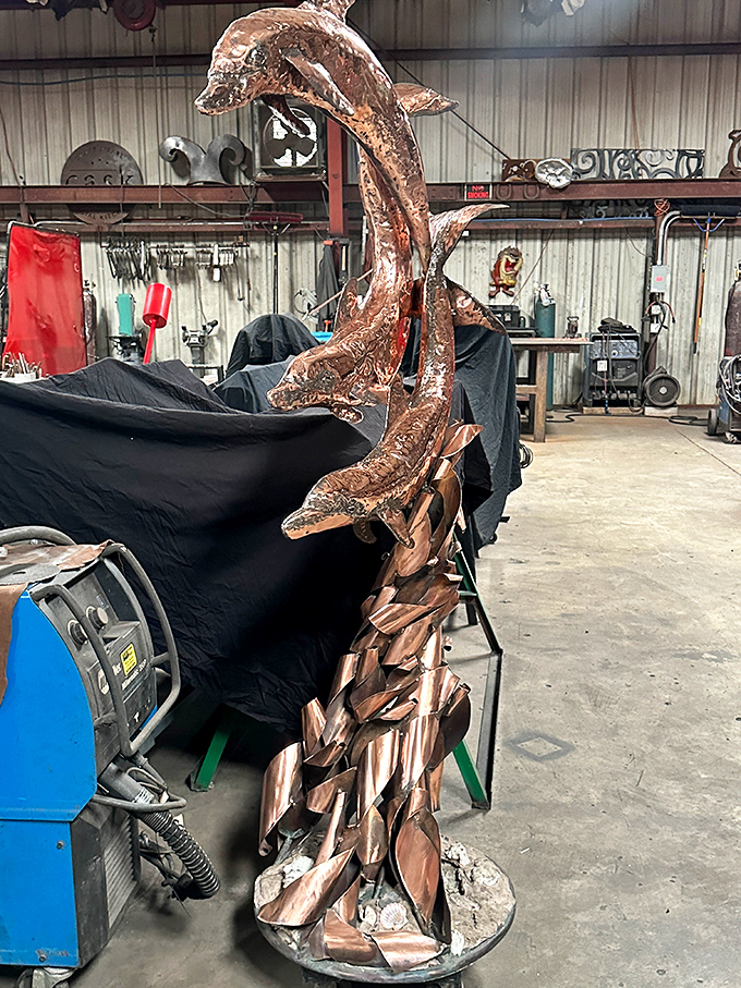 Copper dolphins leap gracefully from a sea of imagination, capturing fluid motion in a material that's anything but liquid.