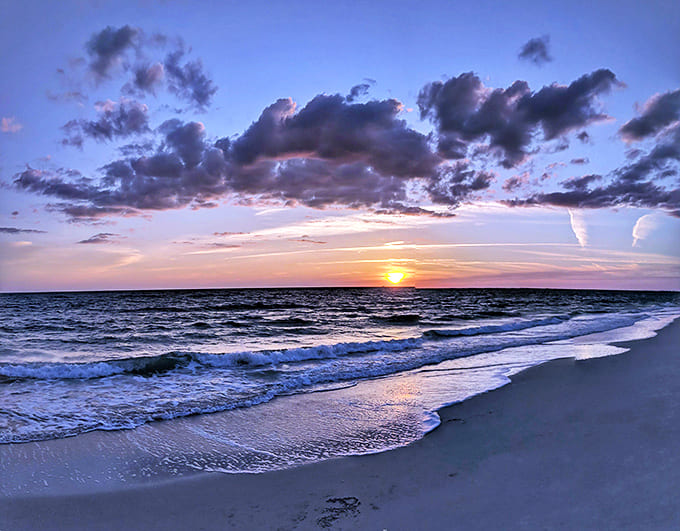 When day bids farewell in a spectacular light show, even the waves pause to admire the performance.