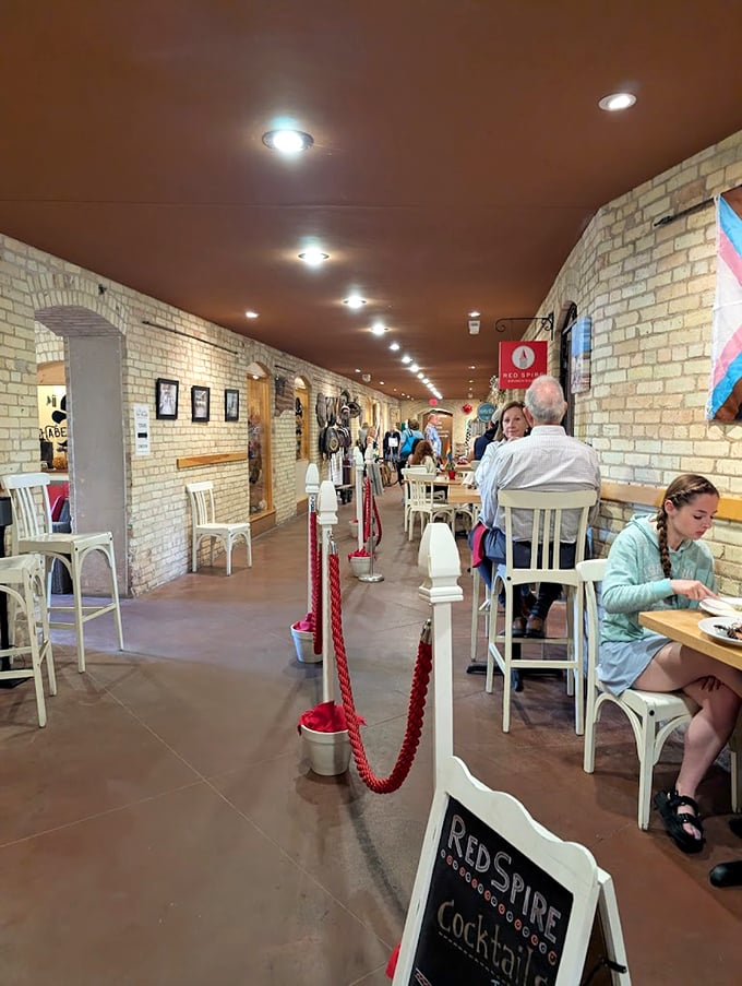 Diners savor local cuisine beneath exposed brick and warm lighting – the ultimate example of adaptive reuse where hospital corridors now host culinary adventures.