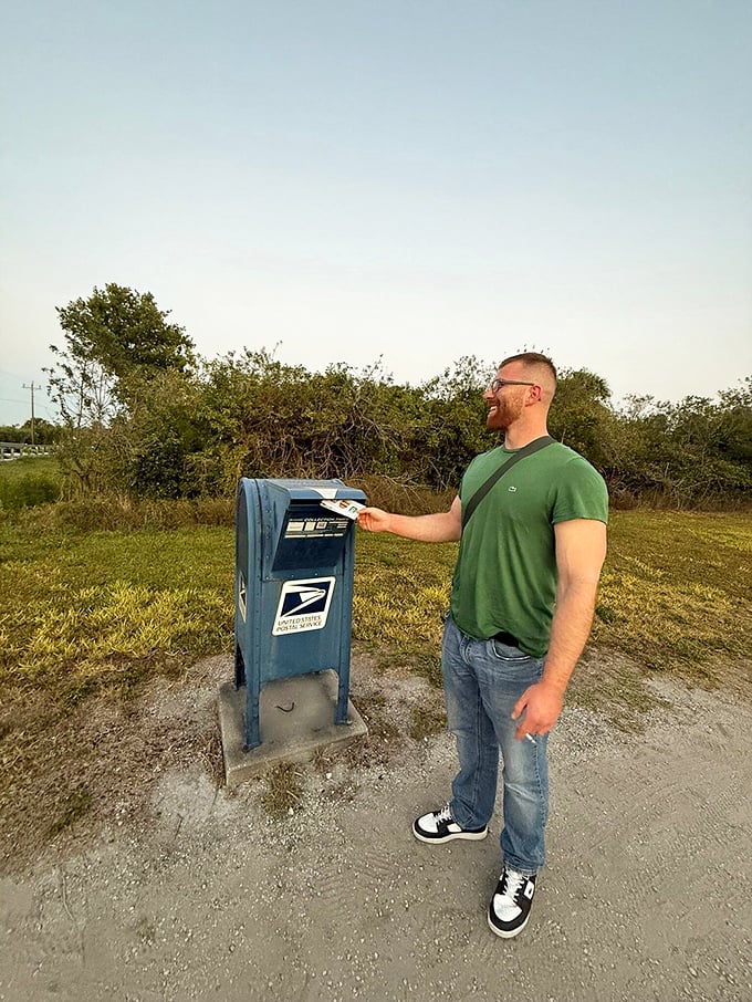 The classic blue mailbox stands ready for service, collecting correspondence from visitors who've made the pilgrimage to postal history.