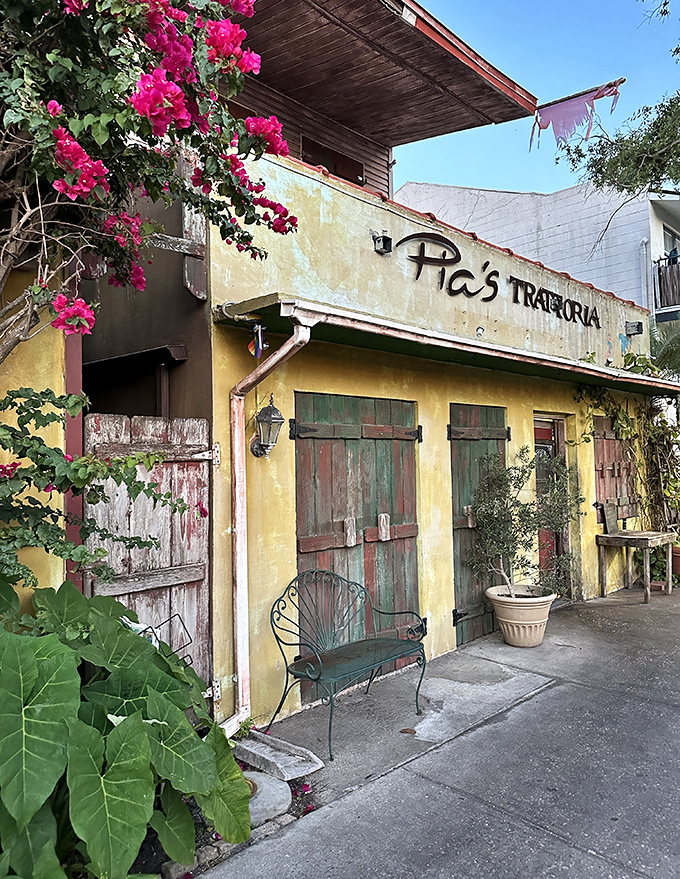 Pia's Trattoria's weathered yellow facade and vibrant bougainvillea create the perfect setting for authentic Italian cuisine that transports diners straight to the Mediterranean.