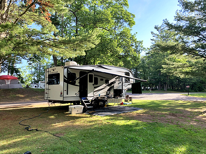 RV camping at F.J. McLain State Park offers the perfect blend of comfort and wilderness under towering Michigan pines.