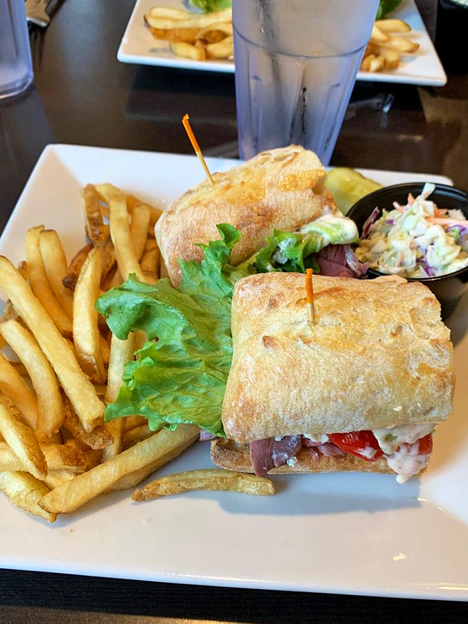 This sandwich isn't just lunch; it's architecture &ndash; layers of fillings between crusty bread, with golden fries standing at attention alongside.