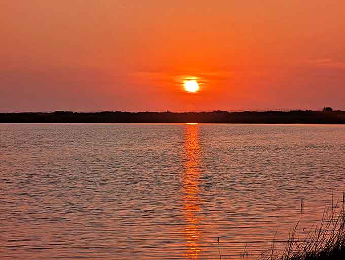 Sunsets over St. George Island's bay side paint the sky in colors that make you want to call everyone you know and tell them to look up.