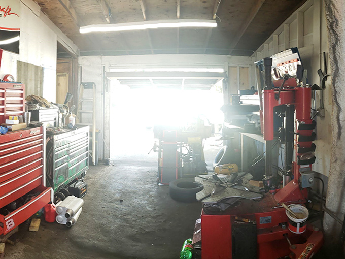 Sunlight streams through the arched doorway, illuminating the practical reality inside this fantastical roadside attraction.