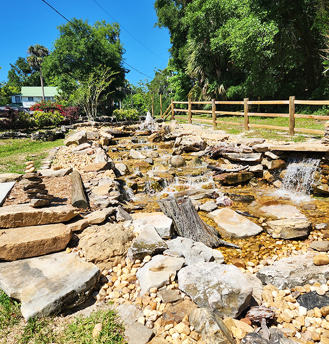 This handcrafted stone waterfall creates a soothing soundtrack for contemplation, proving that even spiritual seekers appreciate good landscape design.