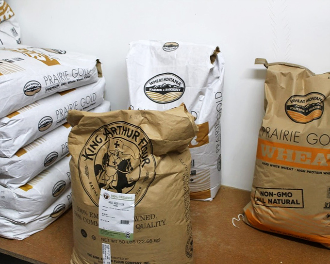 Bags of premium flour stand like sentinels of quality, each one holding the potential for bread that will ruin store-bought loaves forever.