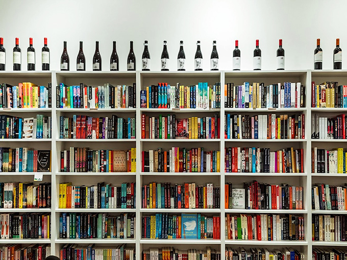 Rainbow-ordered spines create a literary color wheel, each book a doorway to another world, another perspective, another life.