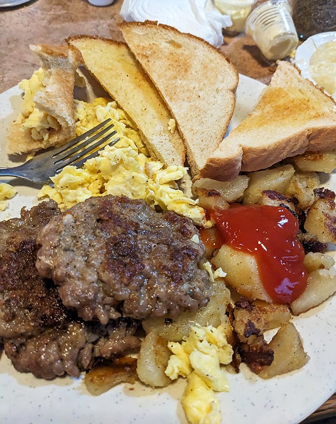 The breakfast that launches a thousand productive days &ndash; eggs, sausage, and potatoes arranged like an artist's palette of morning delights.