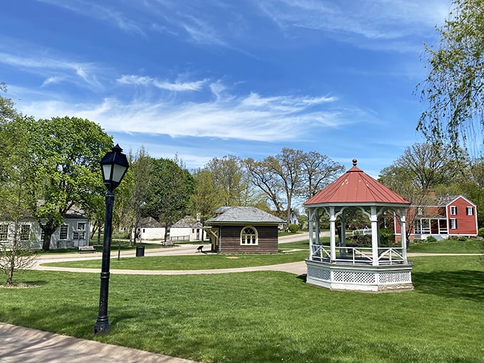 A quintessential American gazebo anchors this peaceful green space, inviting visitors to pause and absorb the village's timeless rhythms.