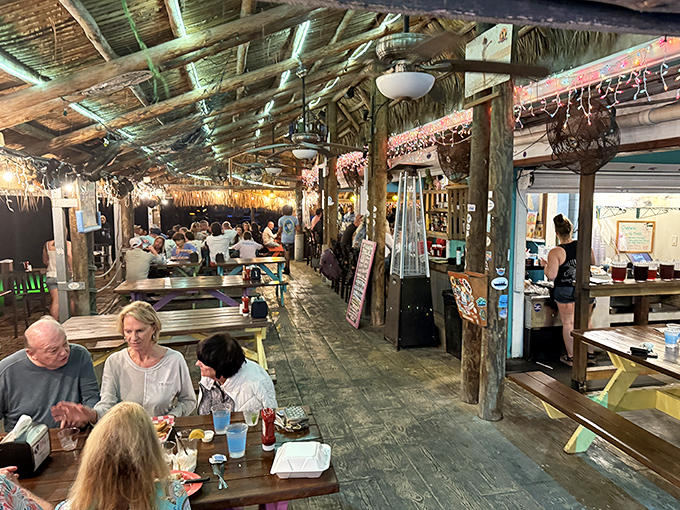 Where strangers become friends over cold drinks and fresh seafood, all under the watchful gaze of swaying palms.