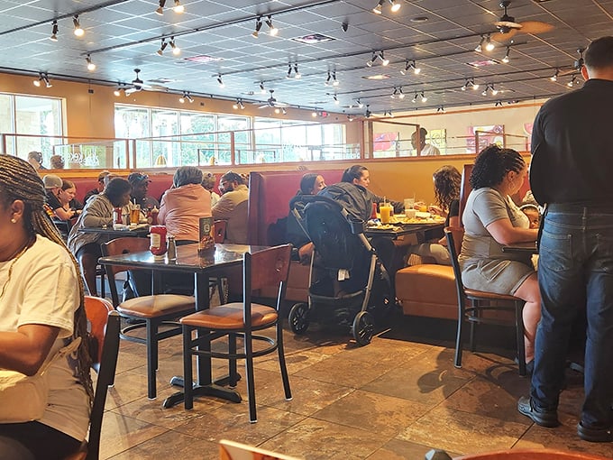 The dining room buzzes with energy as patrons tackle breakfast plates that could double as weight-training equipment.