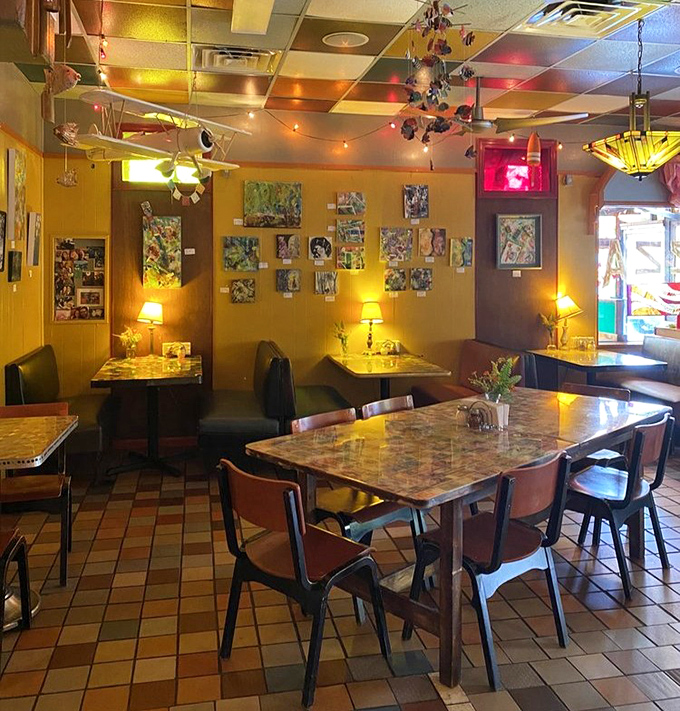 Where eclectic meets electric! Table lamps cast a warm glow over conversations while colorful ceiling tiles create a patchwork overhead canopy.