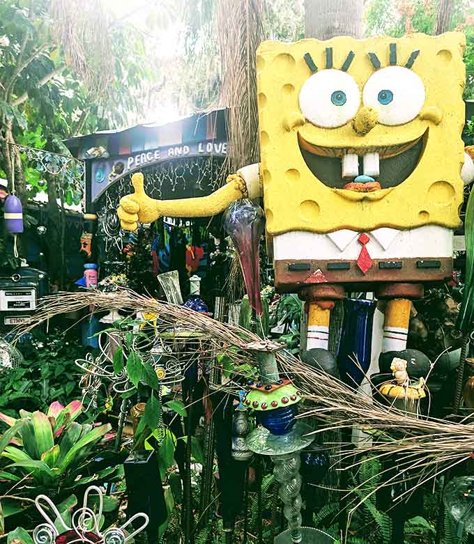 SpongeBob stands guard with a "Peace and Love" sign, looking perfectly at home amid the artistic chaos.