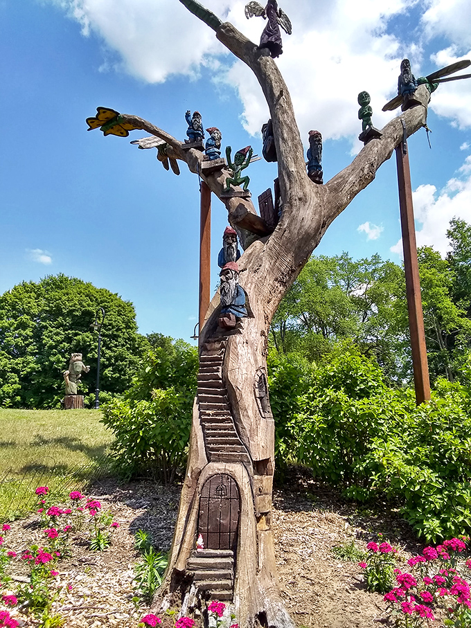 This fairy dwelling carved into a dead tree trunk features tiny staircases and doorways where woodland sprites might gather after dark.