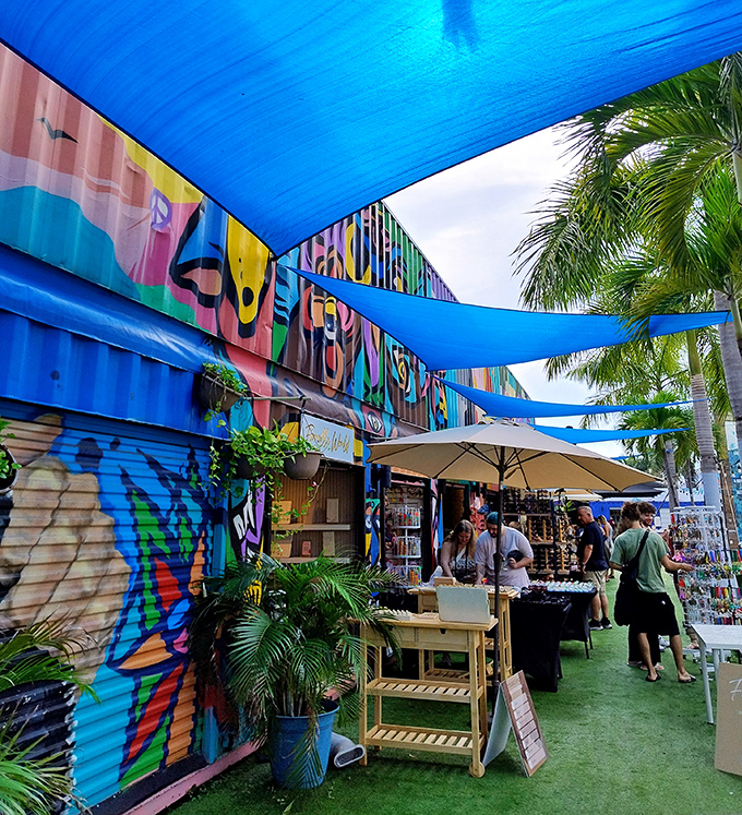 Blue canopies create cool oases in this market alley, where shoppers browse unique finds while protected from Miami's enthusiastic sunshine.
