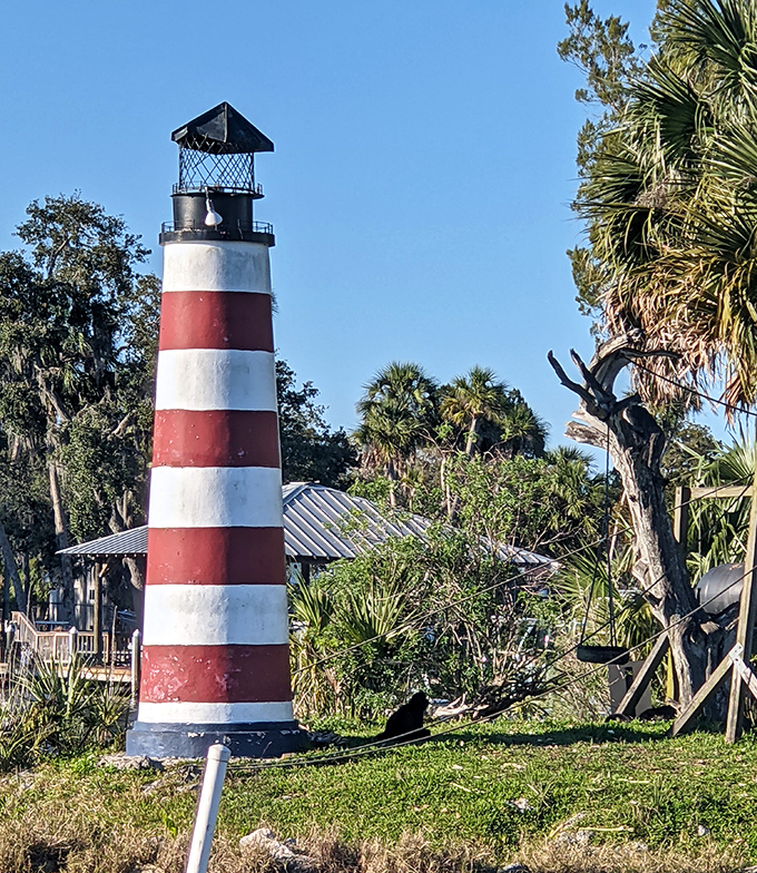 The red and white lighthouse stands as a quirky landmark on this tiny island, serving no navigational purpose but adding undeniable charm.