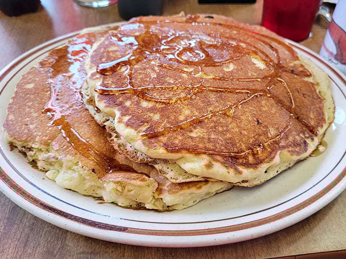 Pancakes so fluffy they practically hover above the plate, glistening with melted butter and begging for a maple syrup baptism.