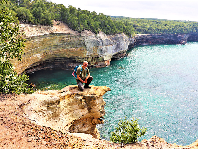 A lone hiker pauses to absorb the panoramic view, finding that perfect moment when nature makes you feel both tiny and infinite.