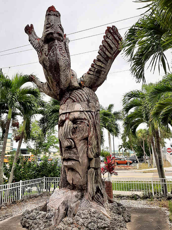 Intricate carving details and an eagle headdress showcase the remarkable craftsmanship of this Whispering Giants statue.