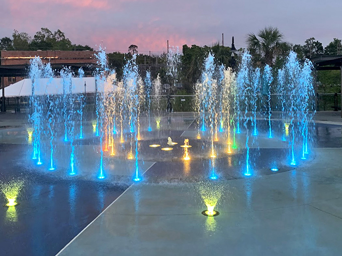Imagination Fountain transforms into a neon playground after dark, where Tallahassee families gather to watch water dance with light.
