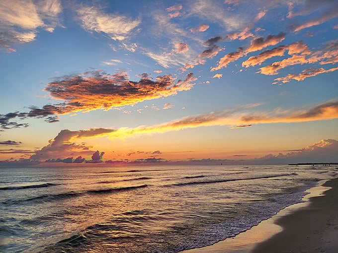A beachgoer could celebrate the joy of Keewaydin's pristine waters and golden sunset, where the Gulf of Mexico meets untouched shoreline.