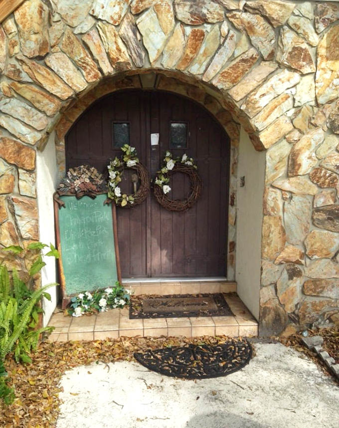 Simply Country Gifts & Southern Belles Tea Room's Victorian mansion with wraparound porch exudes classic Southern charm.