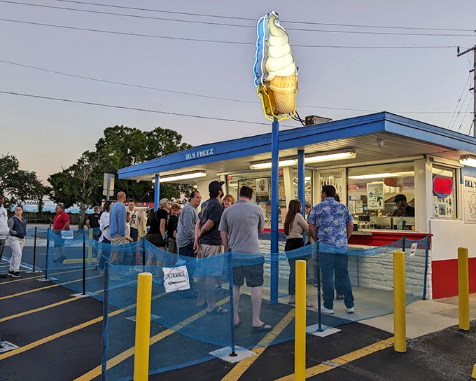 The illuminated ice cream cone sign acts as a beacon for those seeking sweet relief after sunset.