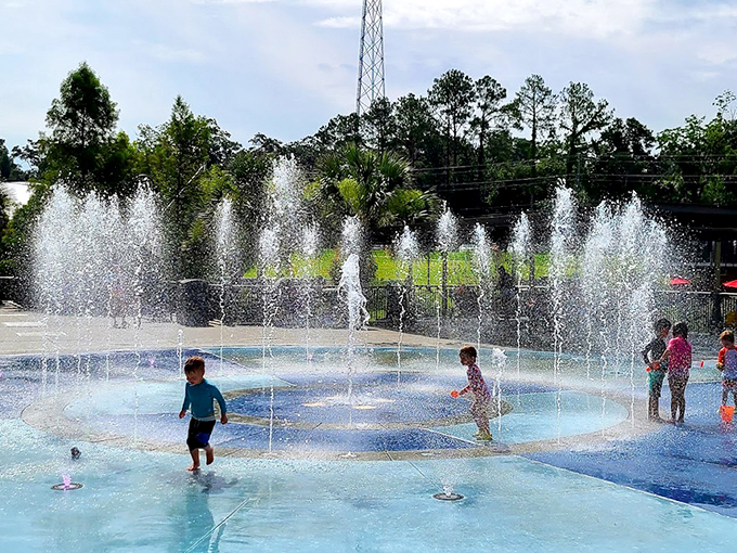Children dash through Tallahassee's Imagination Fountain, finding joy in the simple pleasure of water shooting unpredictably from the ground.