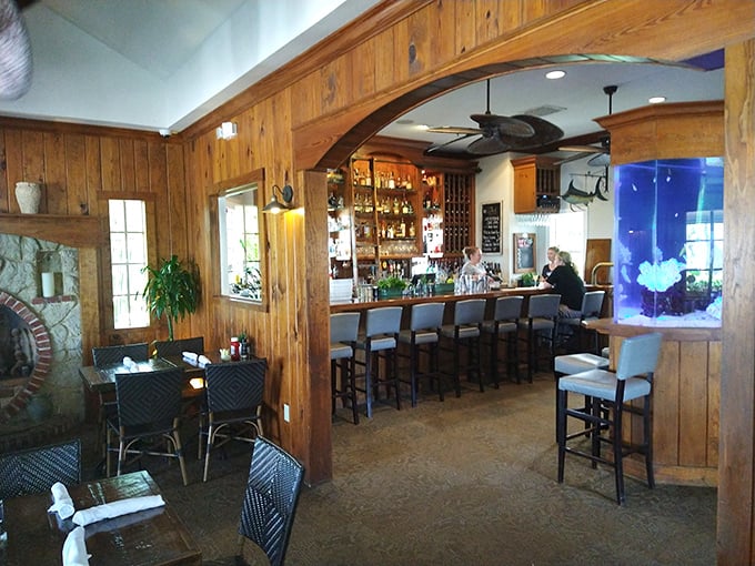 The Waterfront Restaurant's elegant interior features subtle aquarium displays that enhance rather than dominate the sophisticated space. Understated aquatic elegance!