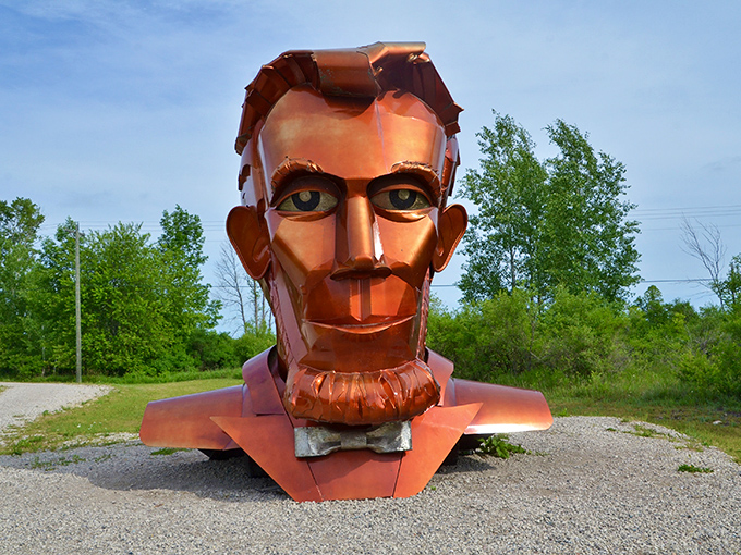 A copper-colored Abraham Lincoln gazes thoughtfully across Awakon Park, his metallic beard catching the Michigan sunlight like a beacon of presidential wisdom.