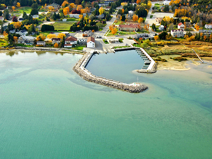 Baileys Harbor's pristine marina cradles boats in its protective arms while turquoise waters stretch toward the horizon &ndash; Door County's aquatic jewel.