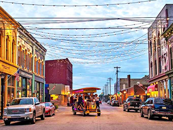Bay City's twinkling downtown streets at dusk &ndash; where string lights crisscross overhead like stars brought down to earth just for evening strollers.