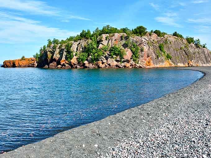 Black Beach's dramatic shoreline creates an otherworldly landscape against Lake Superior's crystal waters.