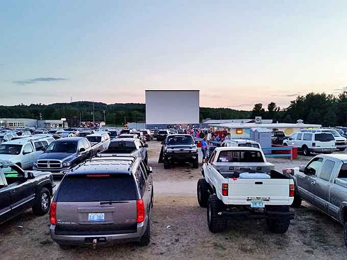 Cars line up at dusk, headlights dimming as the massive screen awaits. Movie magic feels different when shared under Michigan stars.
