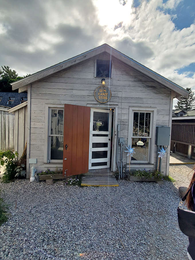 The unassuming exterior of Dam Candy Store beckons with its weathered charm and sunny yellow door &ndash; a sweet portal to sugar-filled adventures.