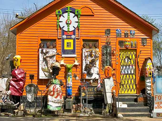 The vibrant orange exterior of Detroit Industrial Gallery pops against the urban landscape, its whimsical facade promising artistic adventures within.