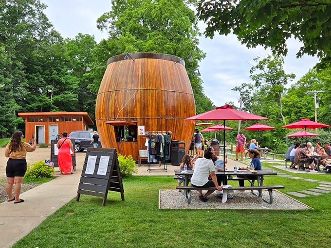 The iconic Douglas Root Beer Barrel stands proudly among the trees, its wooden staves gleaming in the Michigan sunshine like a beacon of summertime joy.