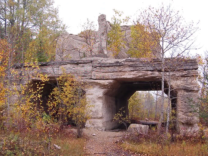 Nature's grand archway: The limestone formation at Fiborn Quarry creates a dramatic entrance, framed by autumn foliage in a perfect Michigan postcard moment.