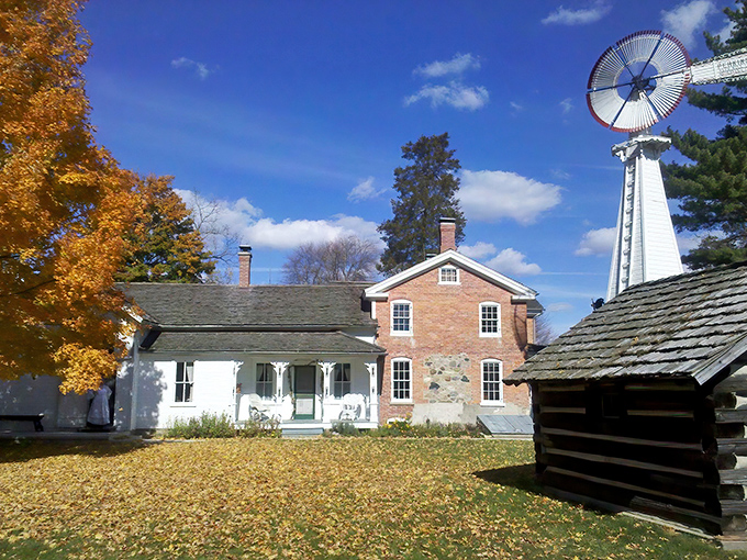 The farmhouse stands proudly against Michigan's blue sky, its brick and clapboard exterior whispering stories from another century.