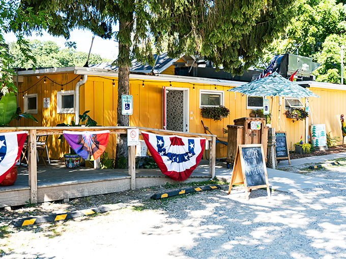 The sunshine-yellow exterior of The Southerner welcomes visitors with patriotic bunting and a porch that practically begs you to sit a spell.