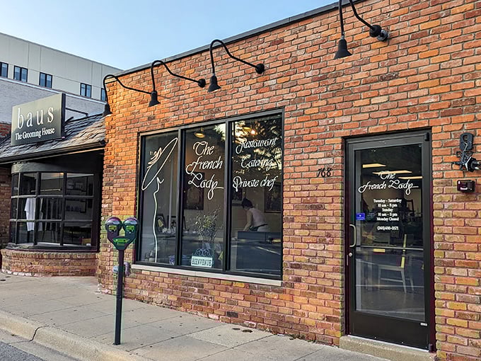 The warm brick exterior of The French Lady beckons passersby with its understated charm and promise of authentic French cuisine.