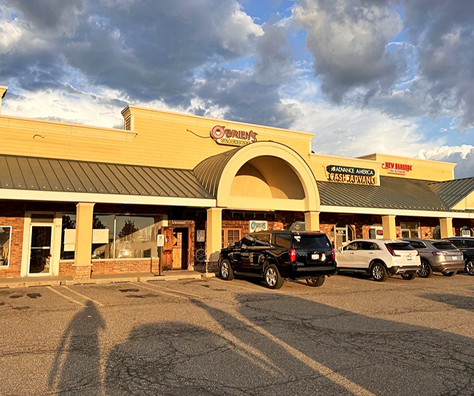 O'Brien's Crabhouse stands proudly against a dramatic Michigan sky, its yellow exterior promising seafood treasures within.