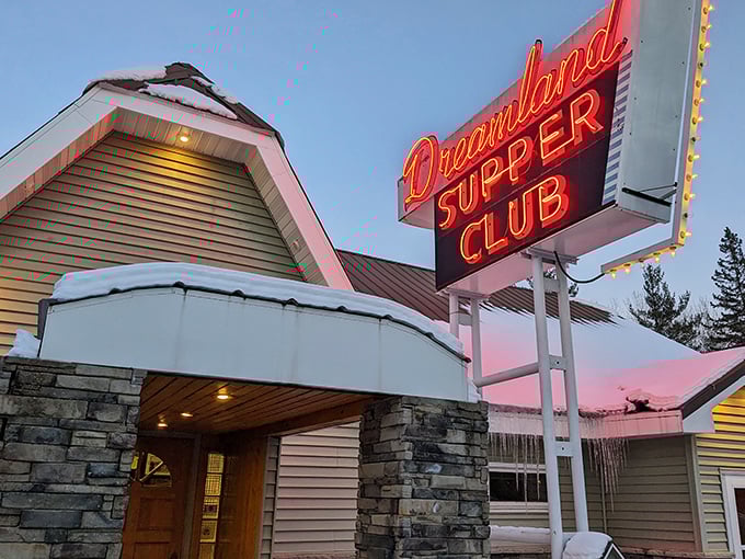 The iconic neon sign beckons hungry travelers like a lighthouse for the famished – Dreamland Supper Club promises delicious refuge ahead.