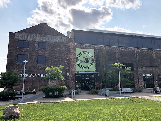 The Outdoor Adventure Center's brick facade stands proudly in Detroit, a former industrial building now housing wild Michigan adventures within its historic walls.