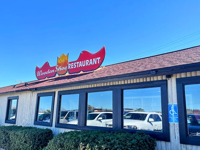 The iconic red wooden shoe sign welcomes hungry visitors, promising breakfast adventures that defy conventional portion sizes.