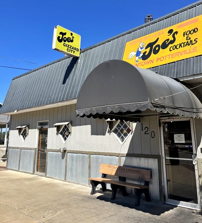 The iconic yellow sign of Joe's Gizzard City stands proudly against the Michigan sky, beckoning hungry travelers with promises of deep-fried delights.