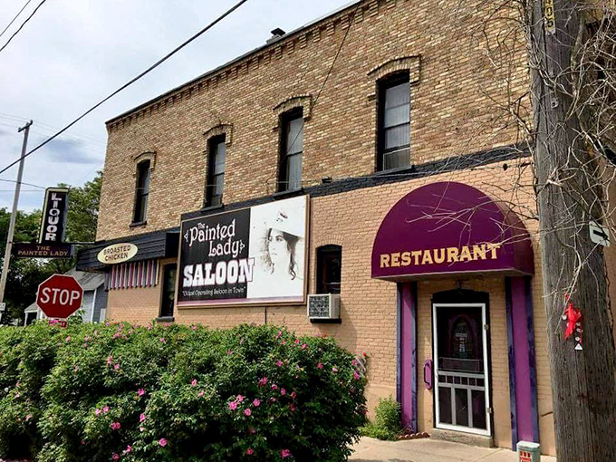 The brick fa&ccedil;ade of The Painted Lady Saloon stands proudly on a Manistee corner, its purple awning and vintage signage beckoning hungry travelers like a colorful oasis.
