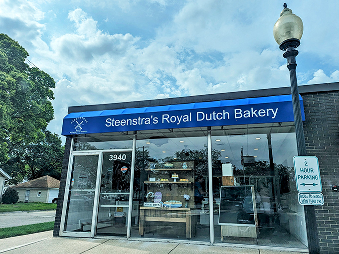 The iconic blue awning of Steenstra's Royal Dutch Bakery stands as a beacon of sweetness in Grand Rapids, promising Dutch delights within these unassuming walls.