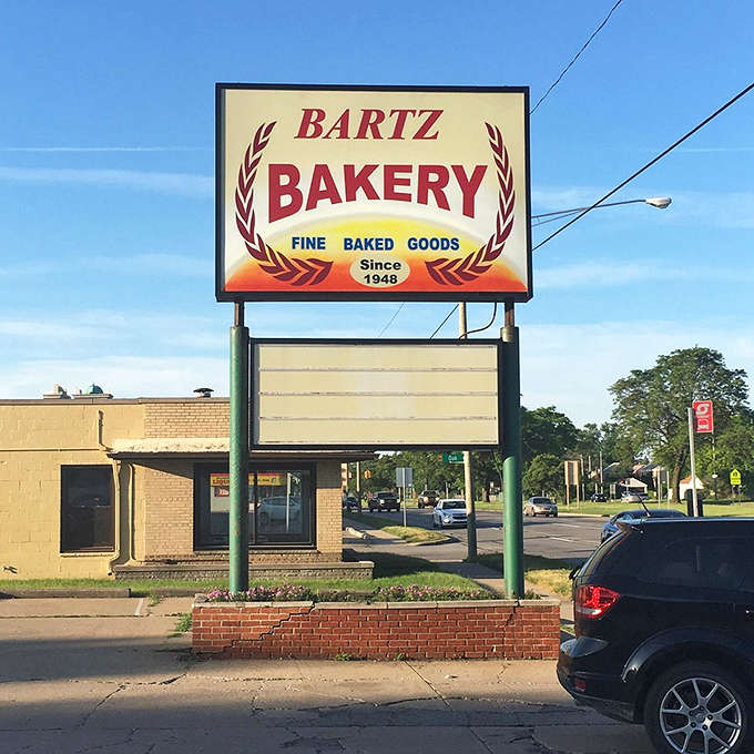 The iconic Bartz Bakery sign stands proud against the Michigan sky, a beacon of buttery hope since 1948.